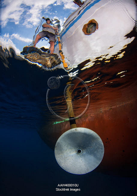 Scientist using hydrophone to listen to whale songs. | Stocktrek Images