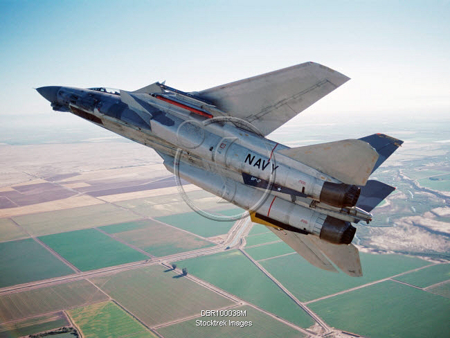 Camouflaged U.S. Navy F-14 Tomcat climbs after takeoff over California ...