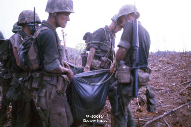 Marines carry a dead comrade in a poncho at the top of Hill 881N during ...