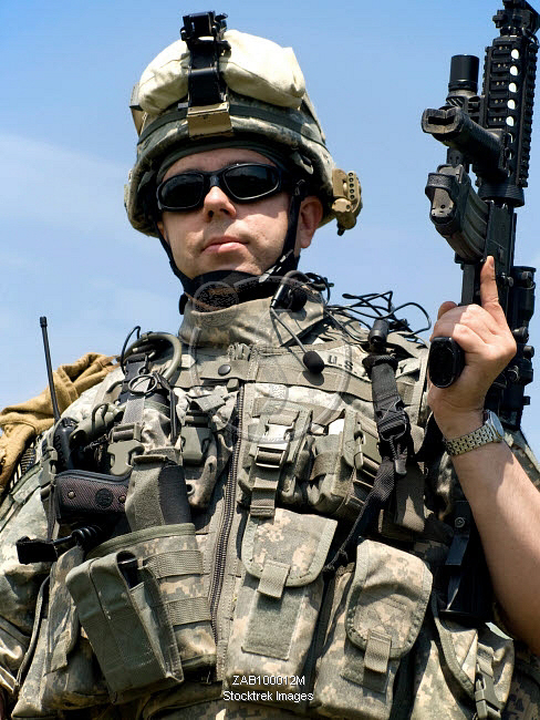 U.S. soldier in camouflage uniform with his rifle. | Stocktrek Images